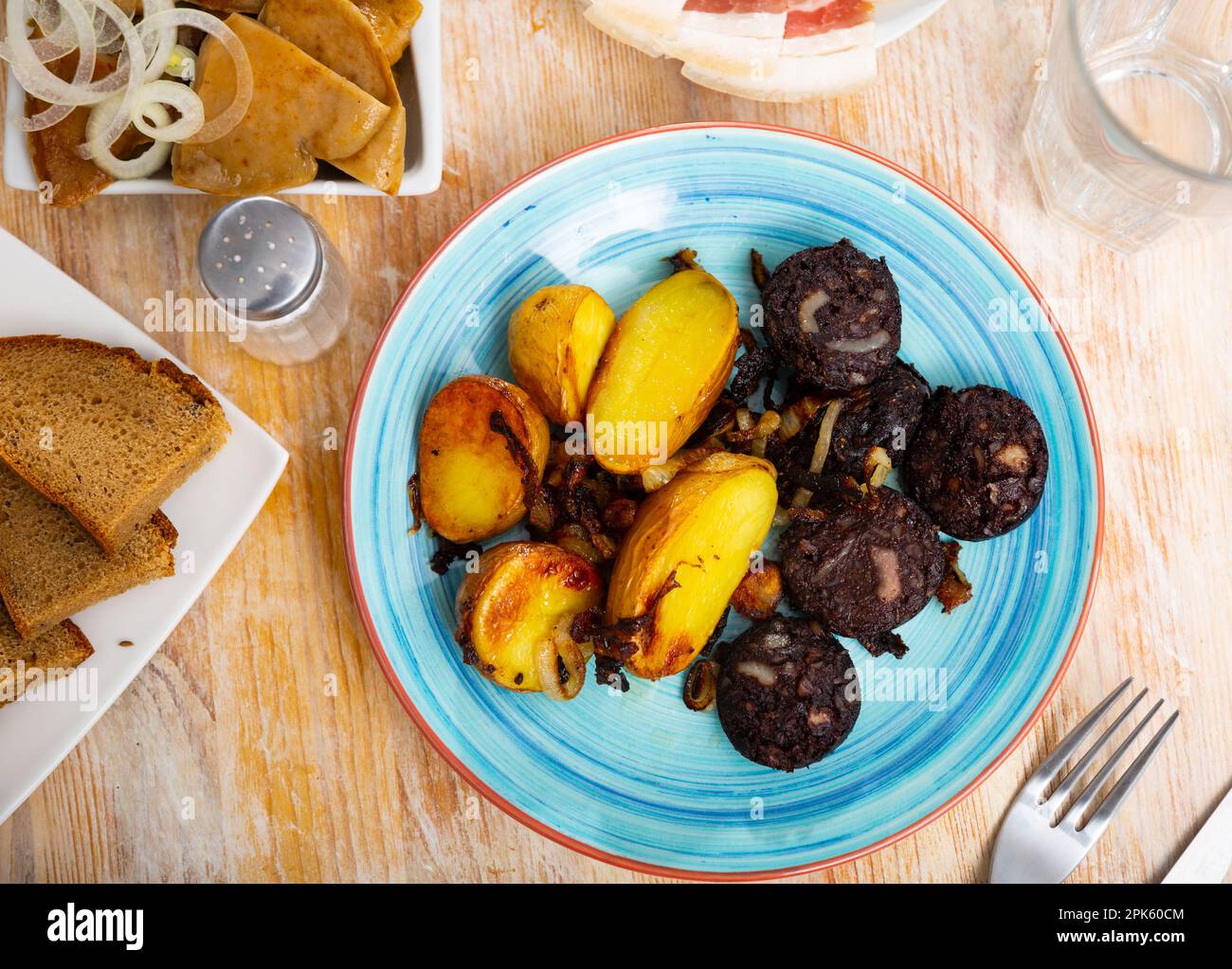 fried black pudding with crispy crust,garnished with baked potatoes in ...