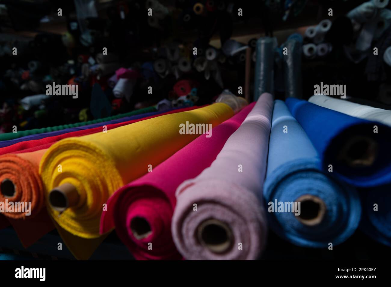 Interior of an industrial warehouse with fabric rolls samples. Small ...