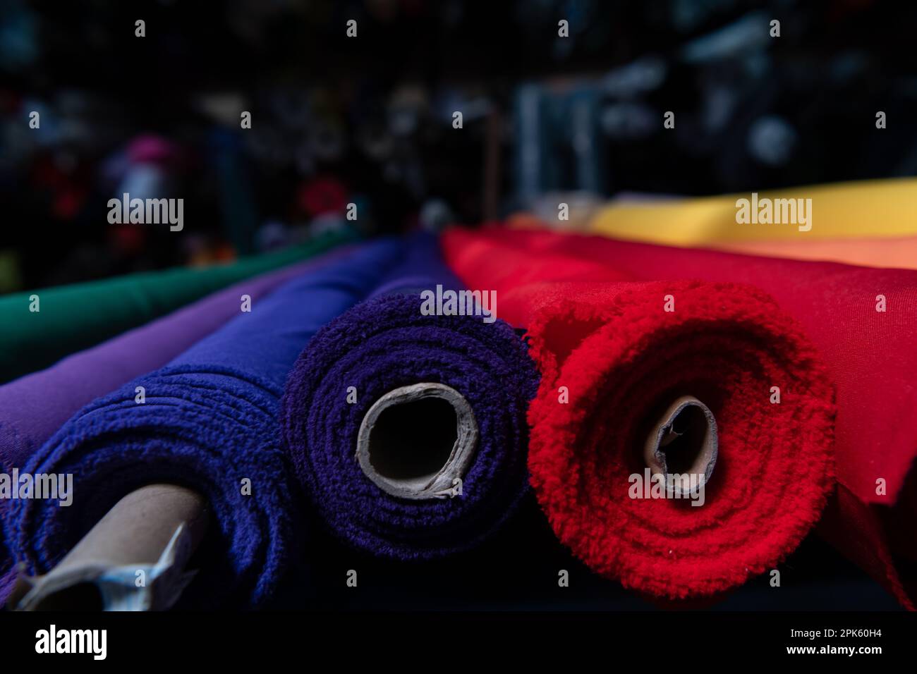 Interior of an industrial warehouse with fabric rolls samples. Small ...