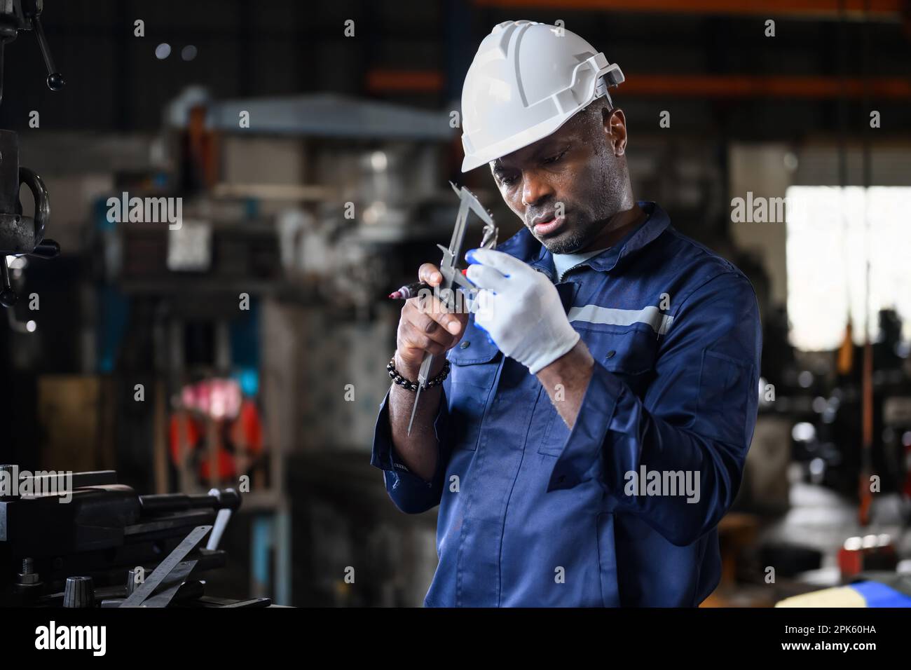 Professional male industrial worker in white hard hat working at ...
