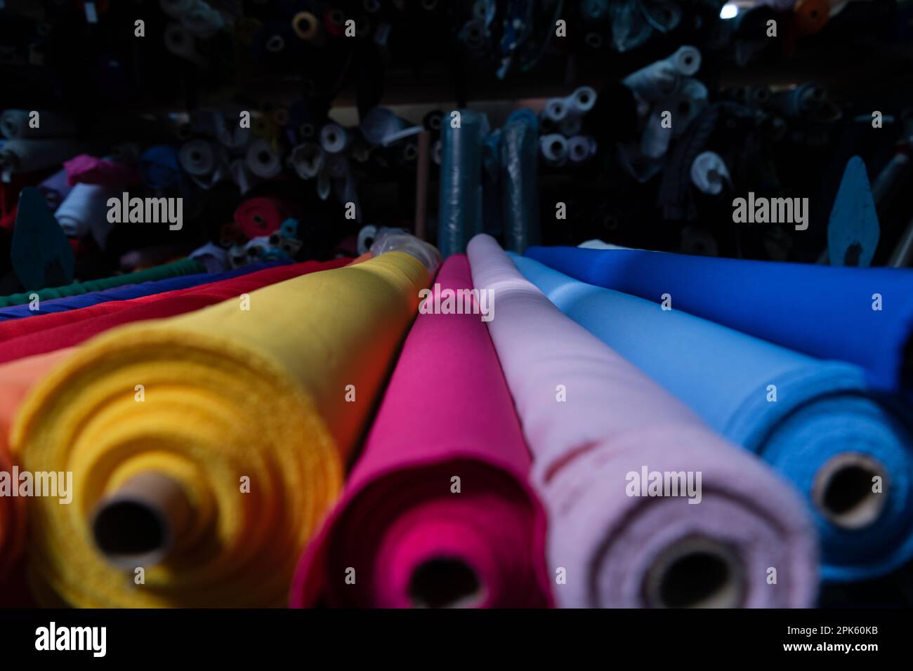Interior of an industrial warehouse with fabric rolls samples. Small ...