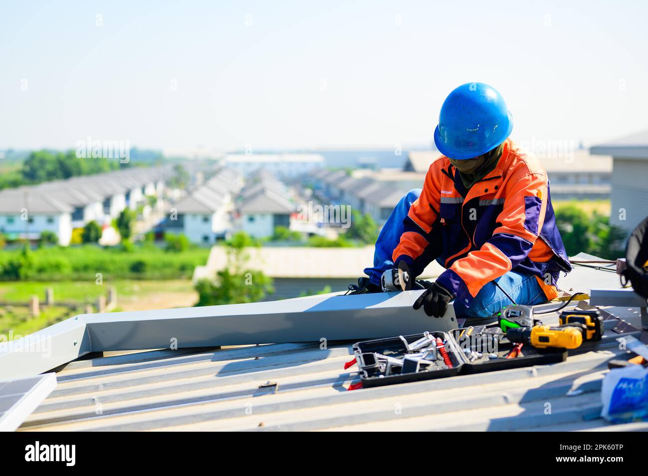 Male technician worker installing solar panels on rooftop of industrial plant Stock Photo - Alamy