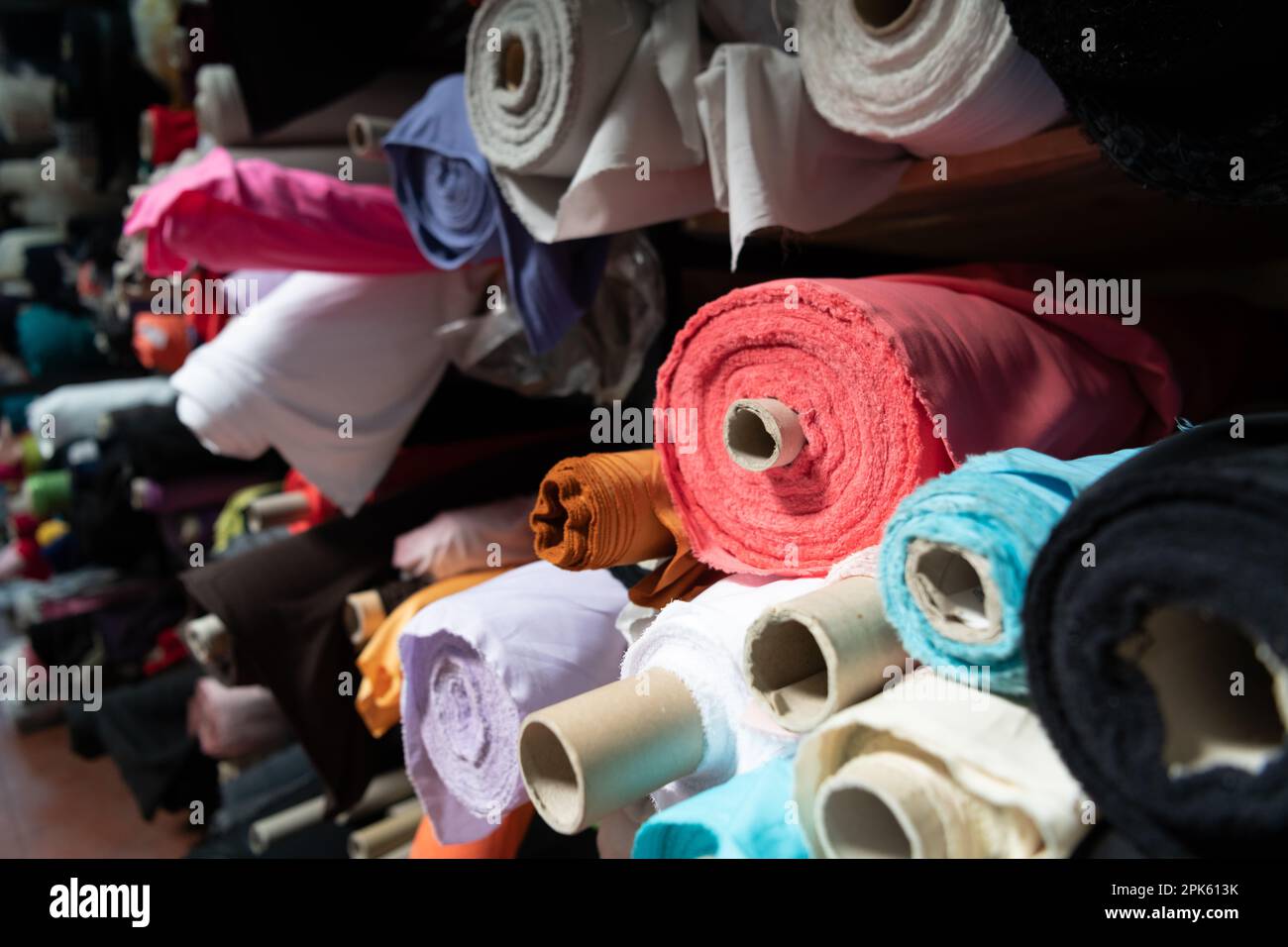 Interior of an industrial warehouse with fabric rolls samples. Small ...