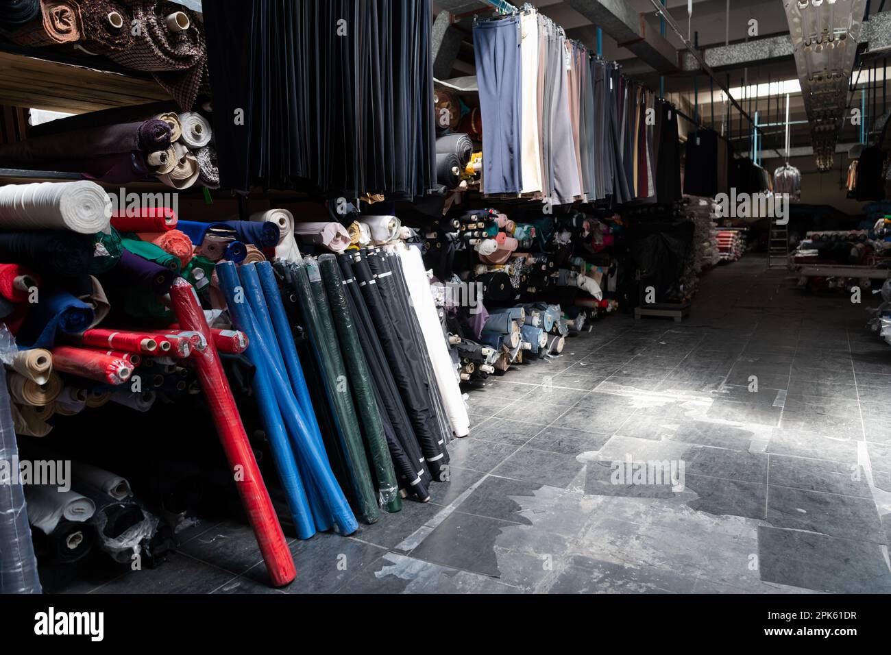 Interior of an industrial warehouse with fabric rolls samples. Small ...