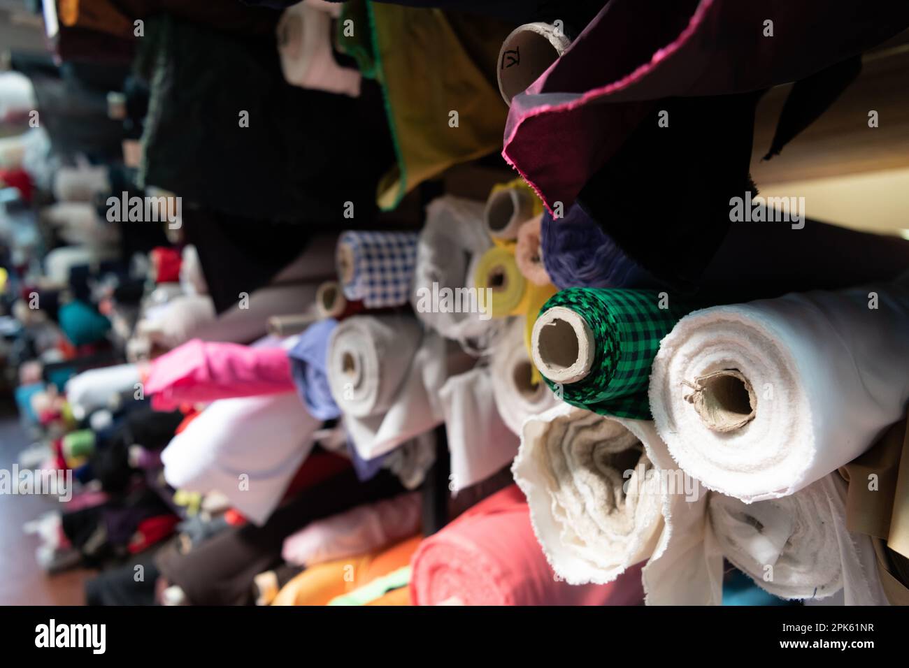 Interior of an industrial warehouse with fabric rolls samples. Small ...