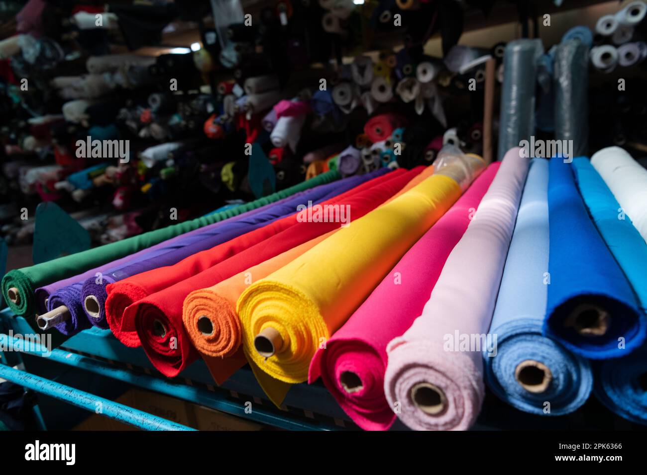 Interior of an industrial warehouse with fabric rolls samples. Small ...
