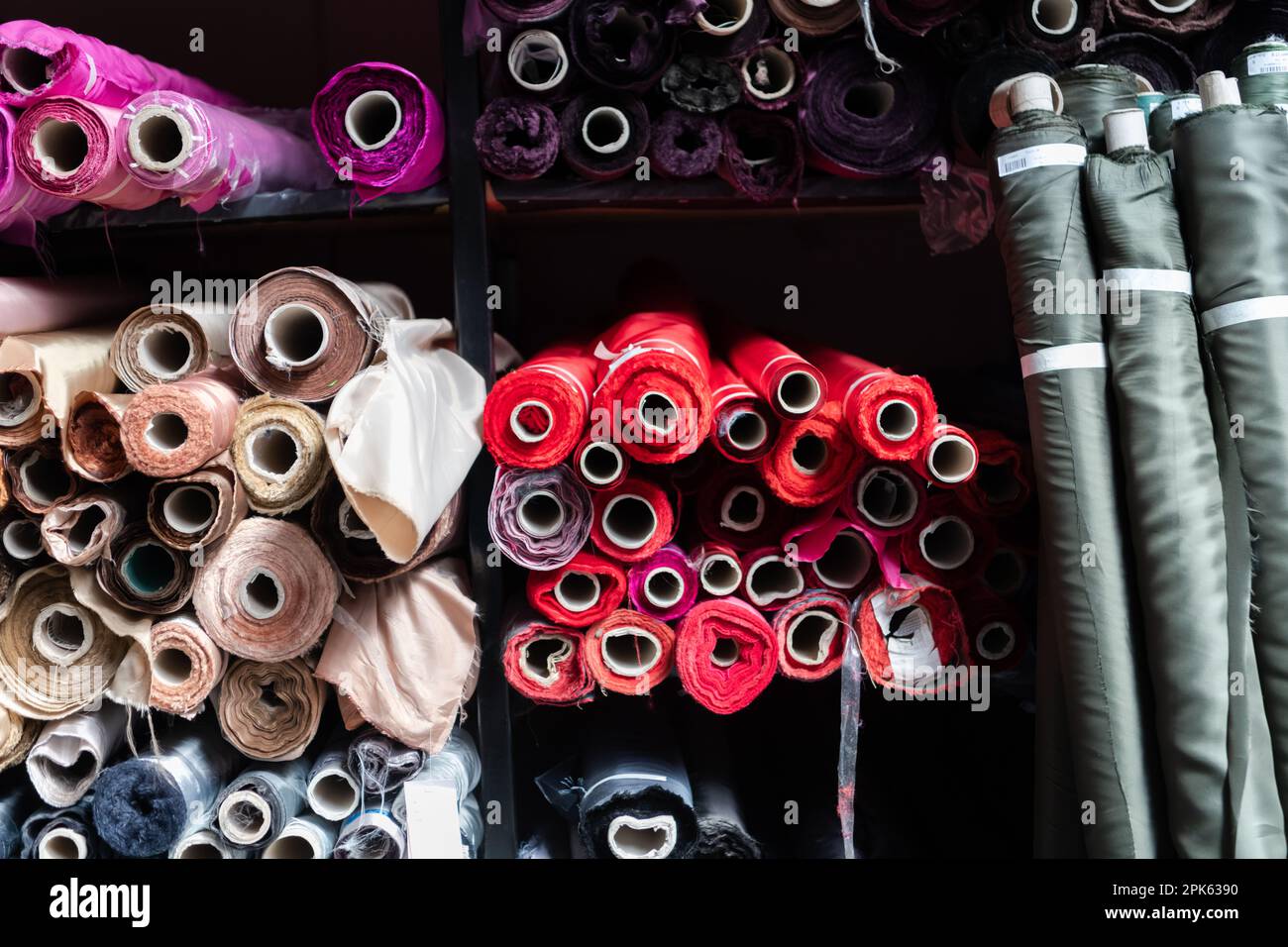 Interior of an industrial warehouse with fabric rolls samples. Small ...