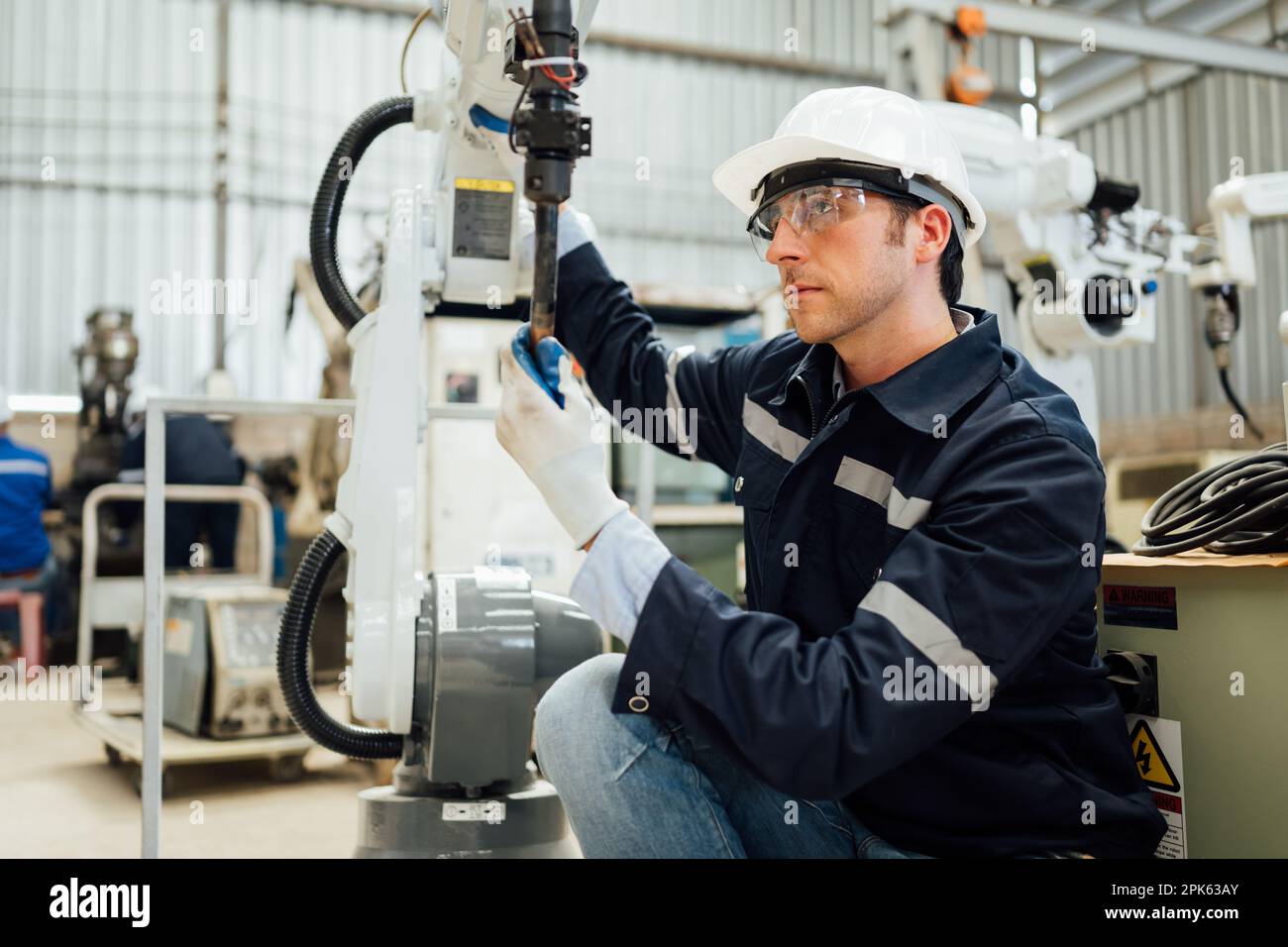 Engineer technician controlling robotic hi-res stock photography and ...
