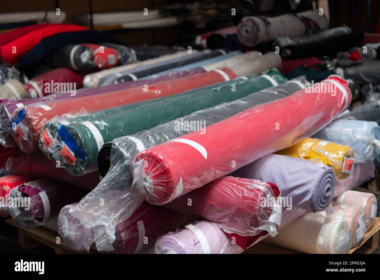 Interior of an industrial warehouse with fabric rolls samples. Small ...