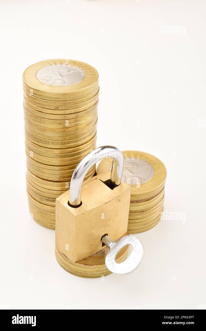 Coin with lock and key on white background Stock Photo - Alamy