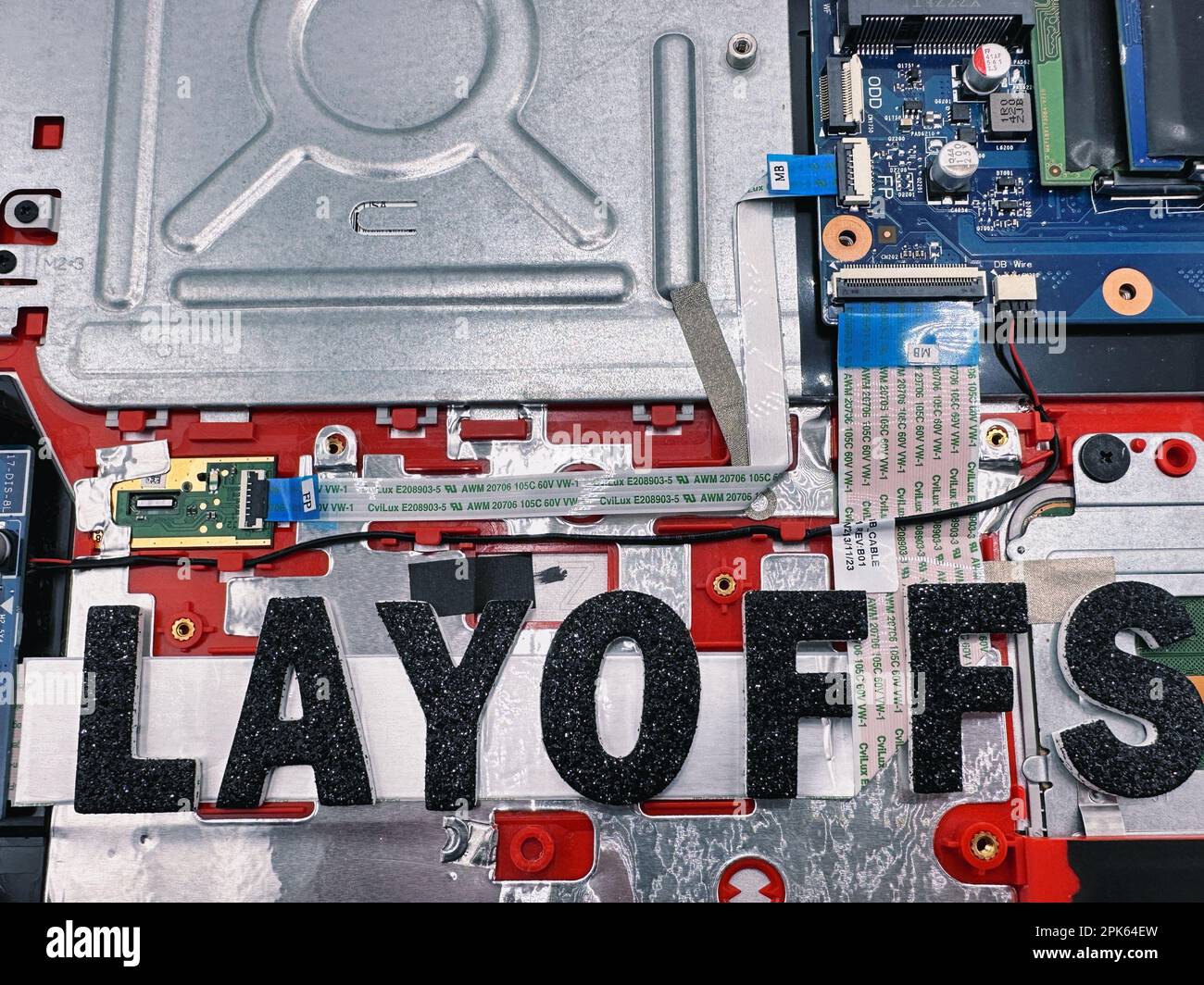 The word Layoffs in black lettering on a laptop computer motherboard ...