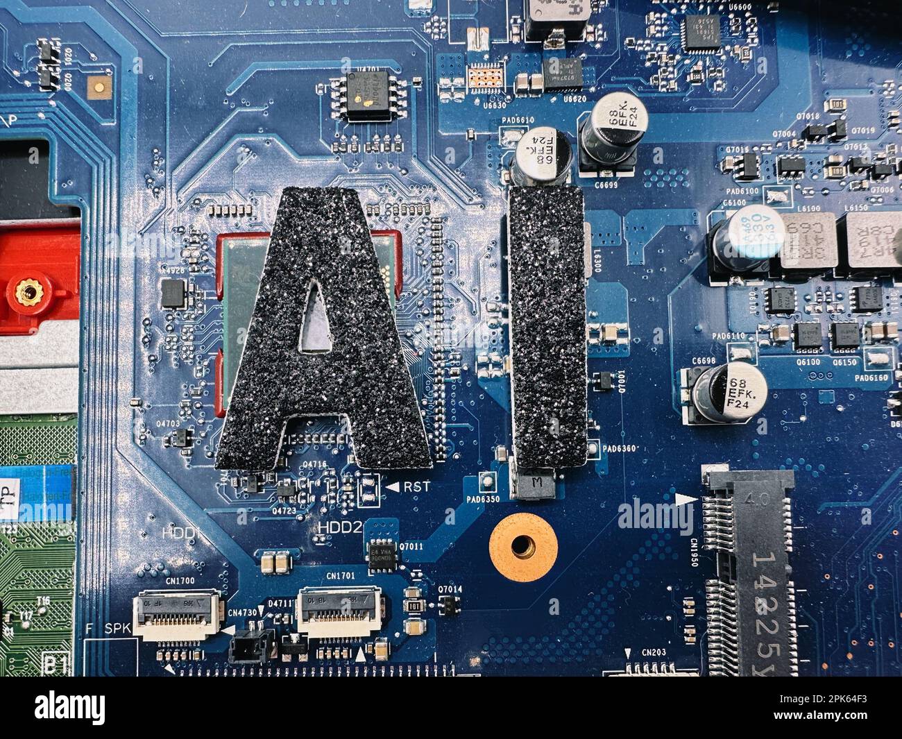 AI short for Artificial Intelligence in black lettering on a laptop computer motherboard to give ...