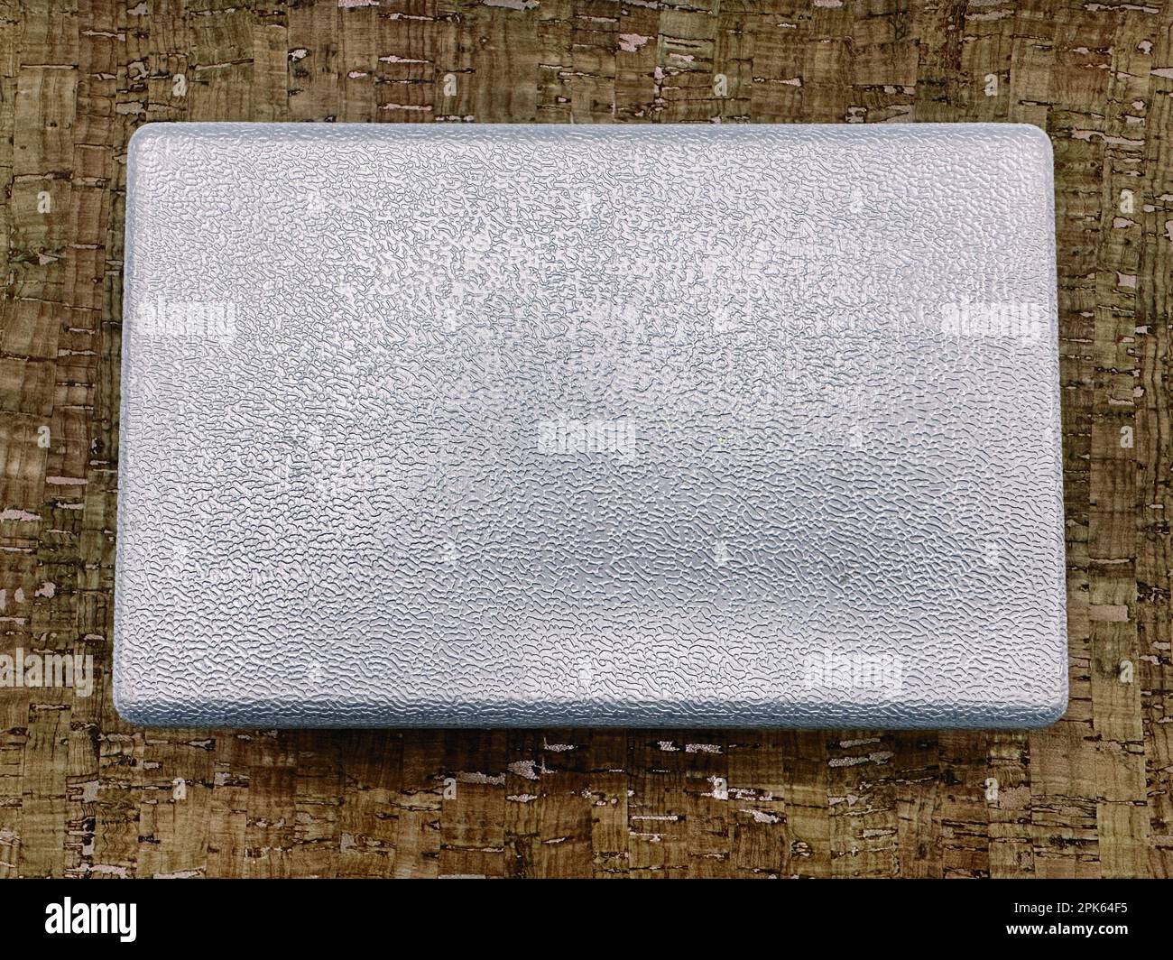 Gray plastic textured surface elevated on green cork leather like ...