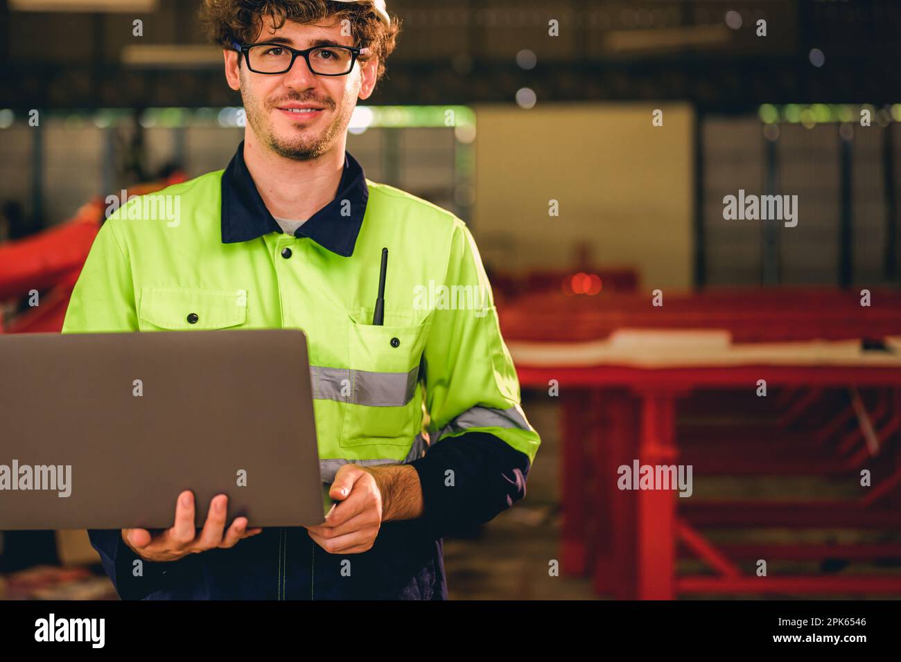 Portrait of happy male mechanical engineer in white hard hat and safety ...