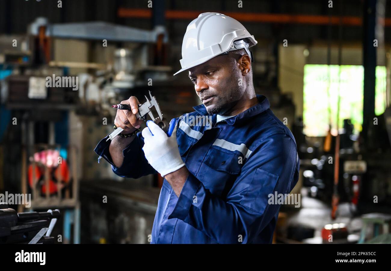 Mechanical engineer with safety hat checking and inspecting machine ...