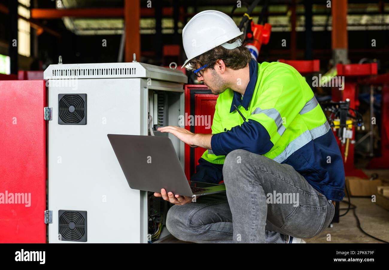 Engineer foreman checking and inspecting machine at industrial factory ...