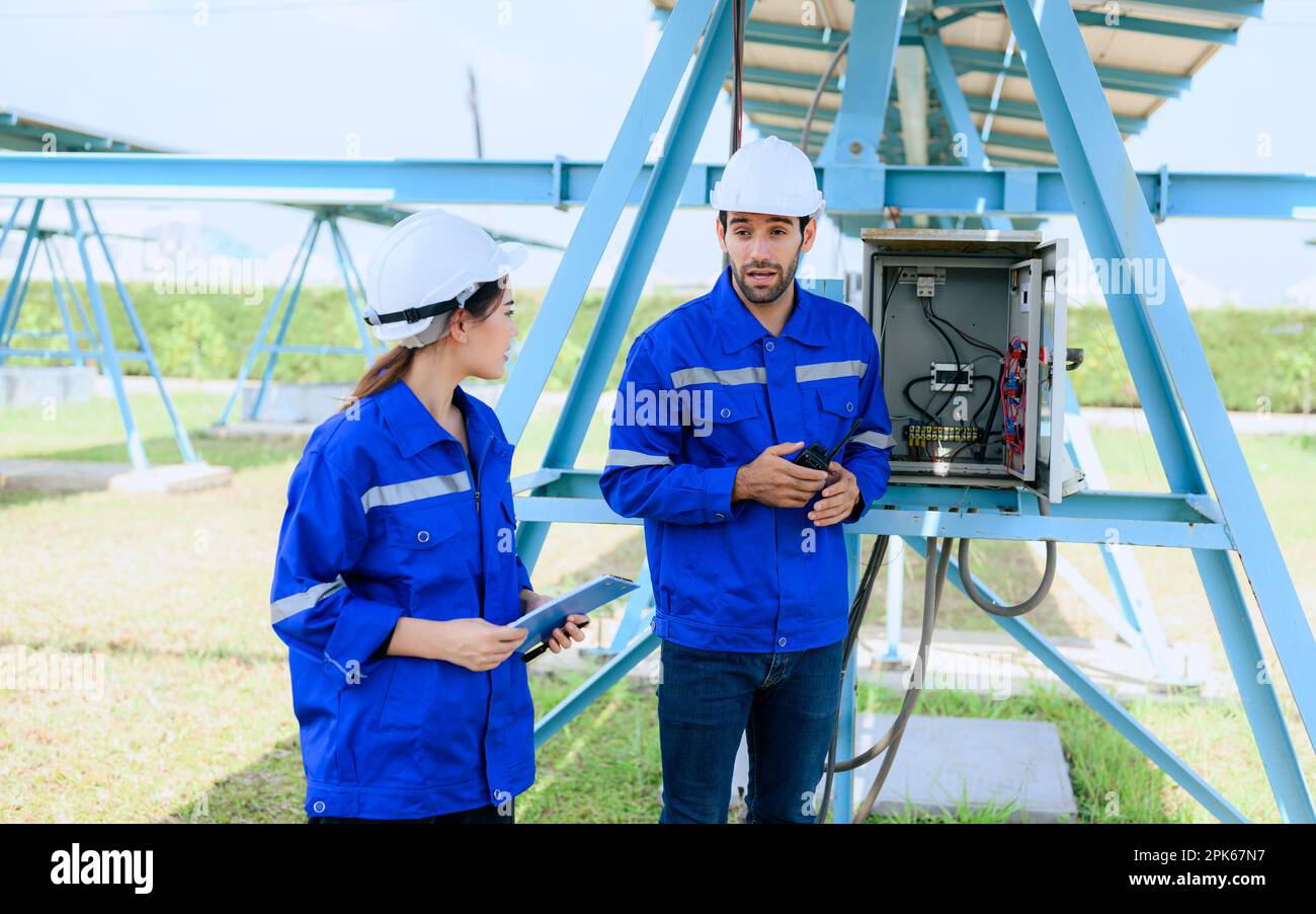 Workers installing solar panels, Engineer team at solar panel farm ...