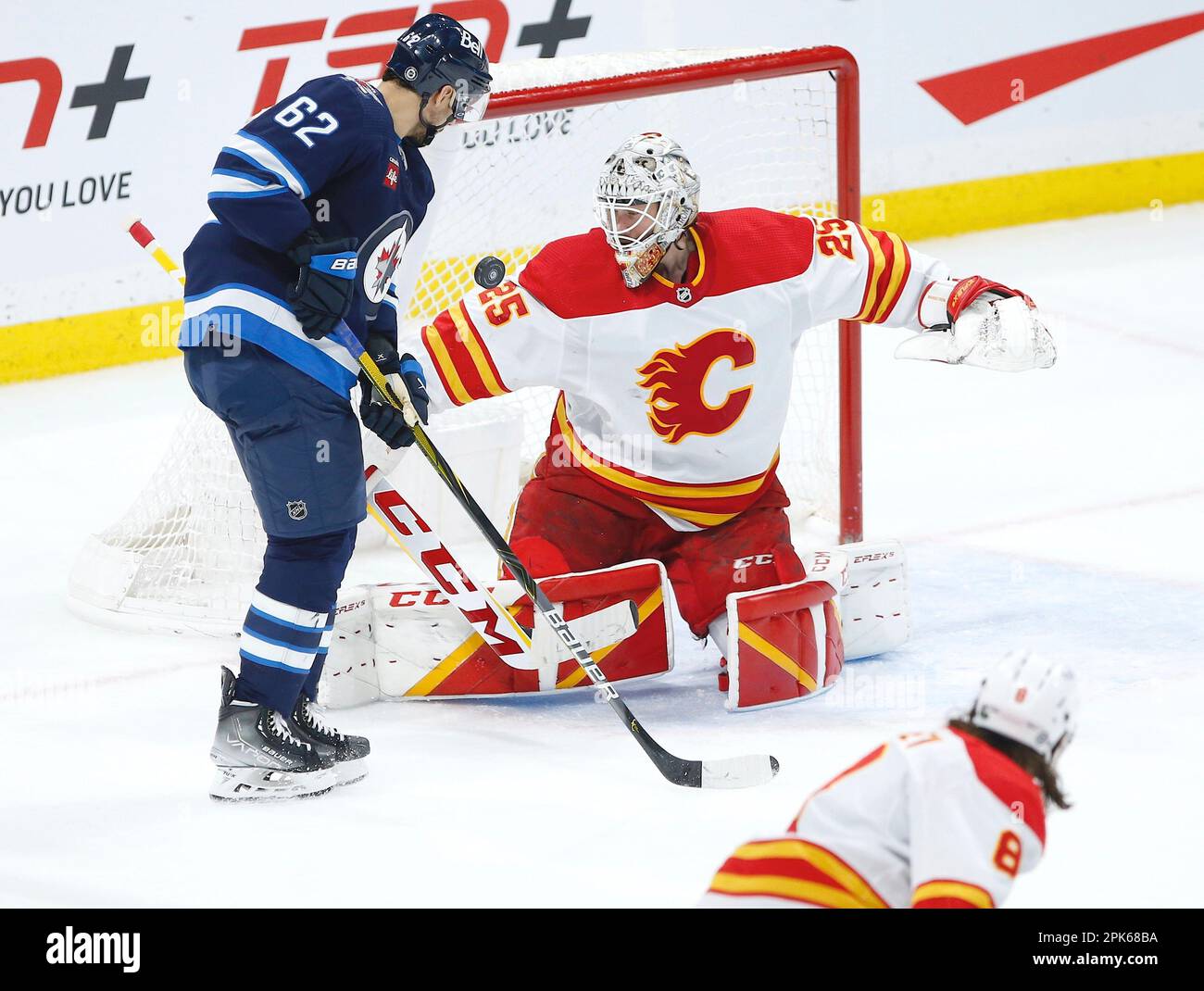 Calgary Flames goaltender Jacob Markstrom (25) makes a save against Winnipeg Jets' Nino ...