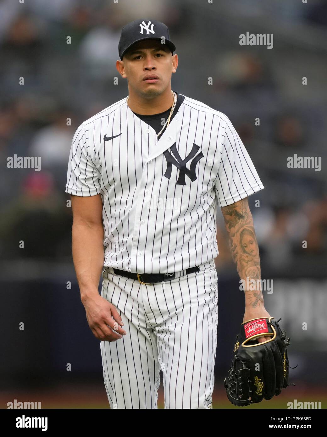 New York Yankees relief pitcher Jonathan Loaisiga walks back to the ...