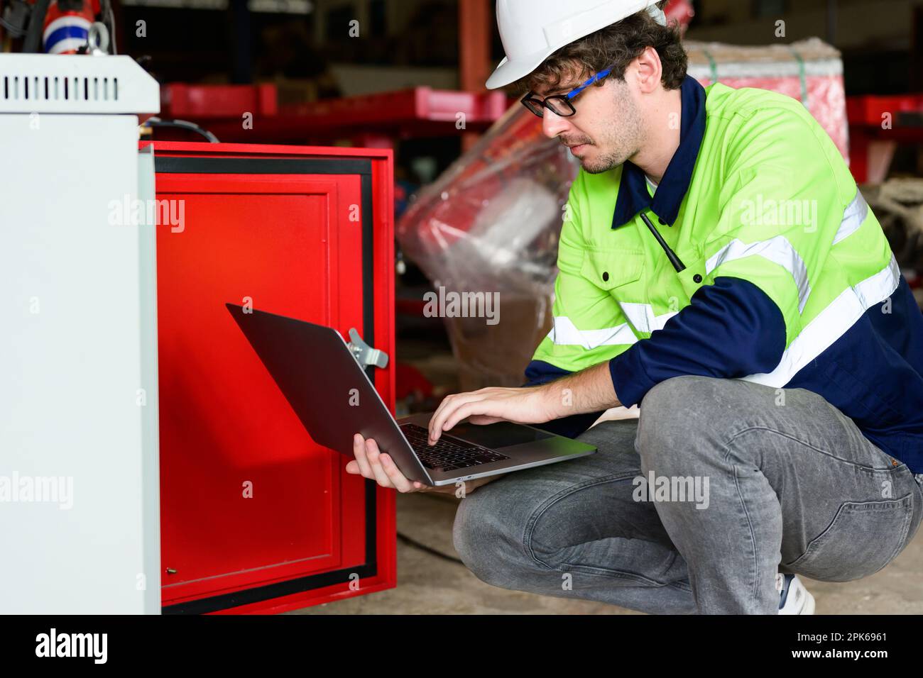 Technician engineer holding robot controller checking and repairing ...