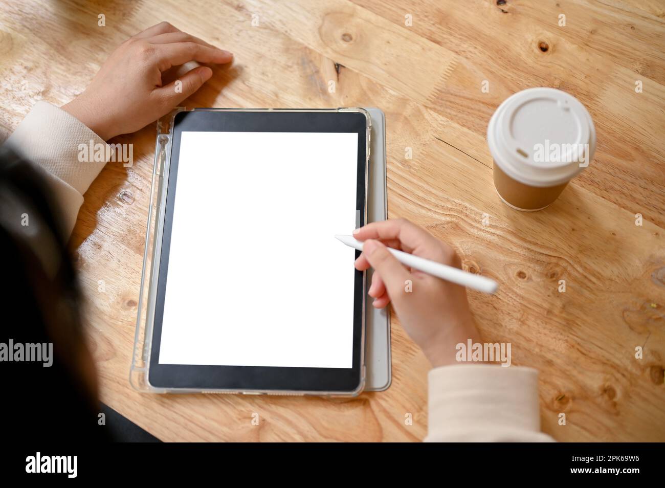 Top view of an Asian woman holding stylus pen, writing or drawing ...