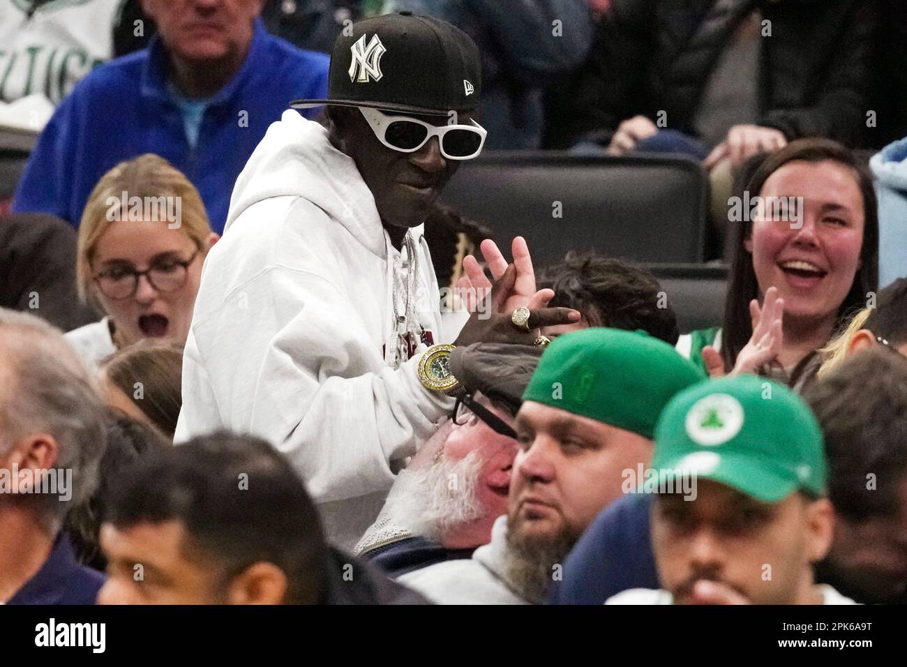 Rapper Flavor Flav shakes hands with fans during the second half of an ...