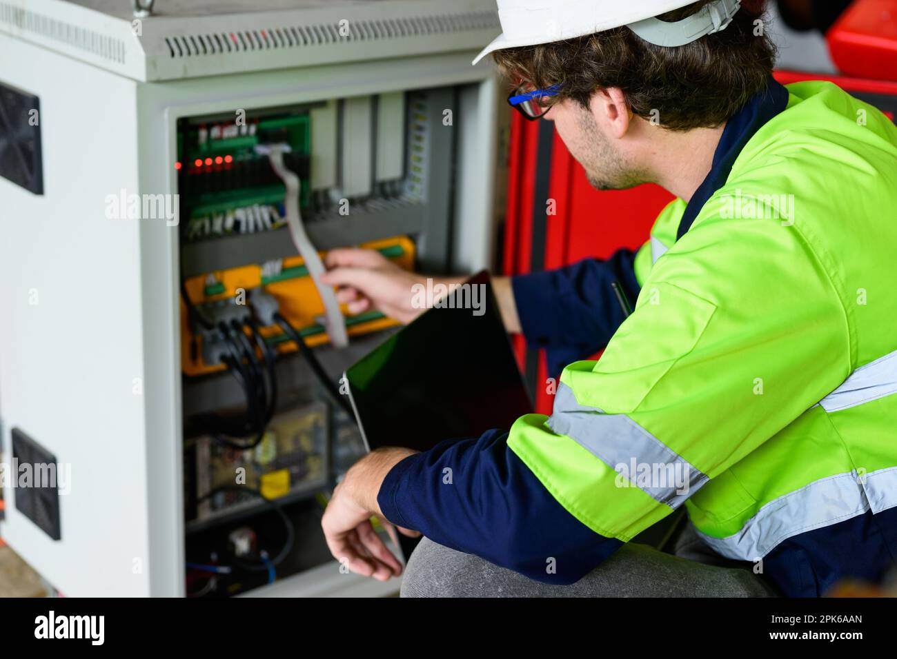Technician engineer holding robot controller checking and repairing ...