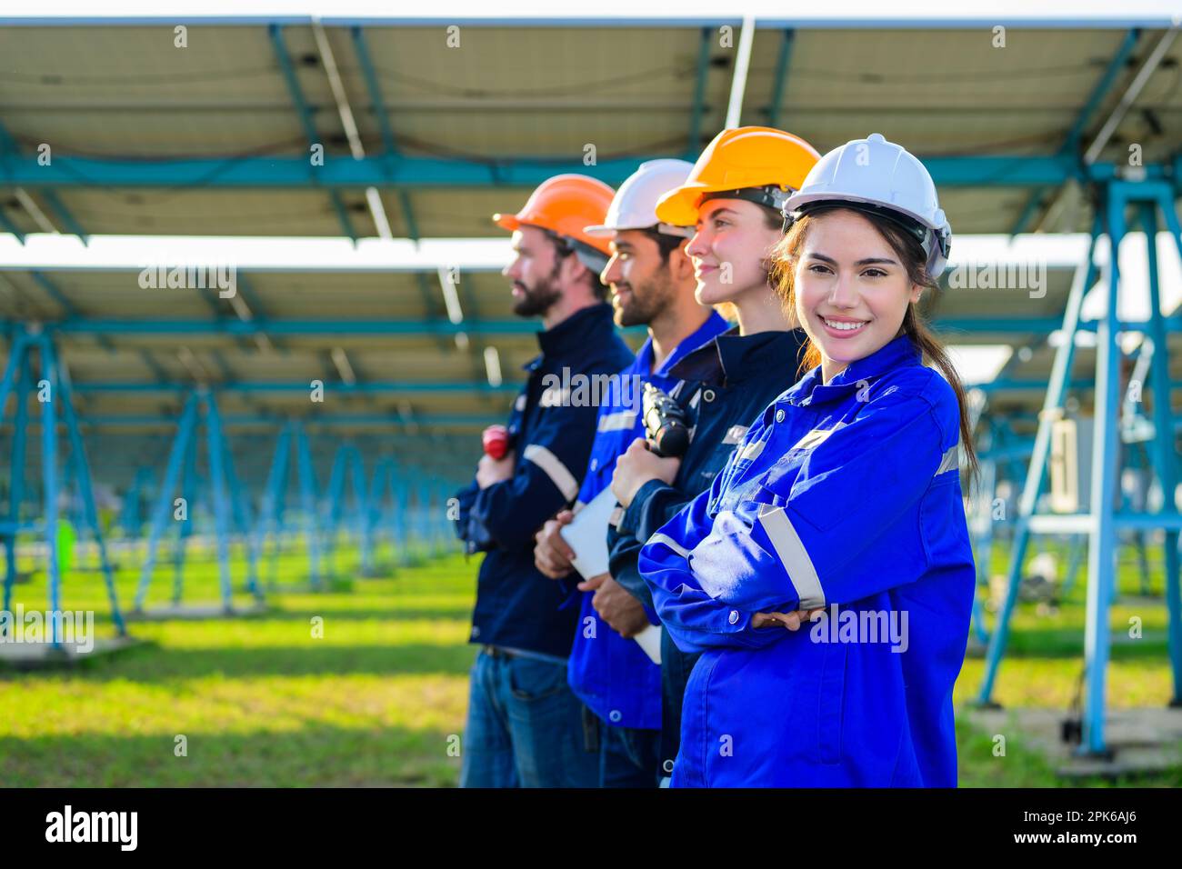 Workers installing solar panels, Engineer team at solar panel farm ...