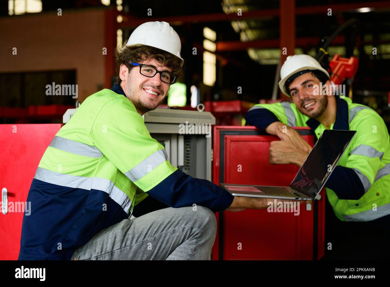 Technician engineer holding robot controller checking and repairing ...
