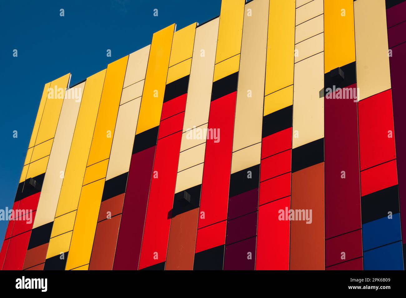 Modern colorful office building exterior with glass facade on clear sky ...