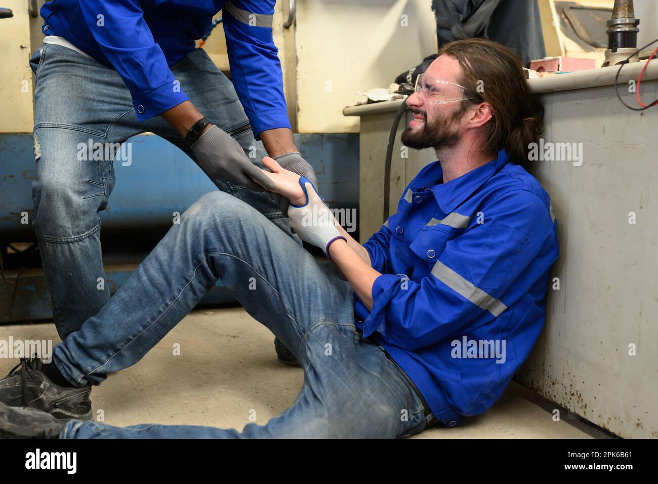 Engineer worker with accident at factory during working Stock Photo - Alamy