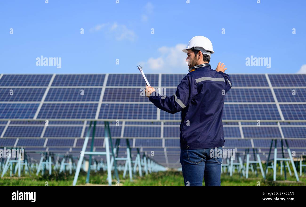 Engineer worker portrait with solar panel at solar farm Stock Photo - Alamy