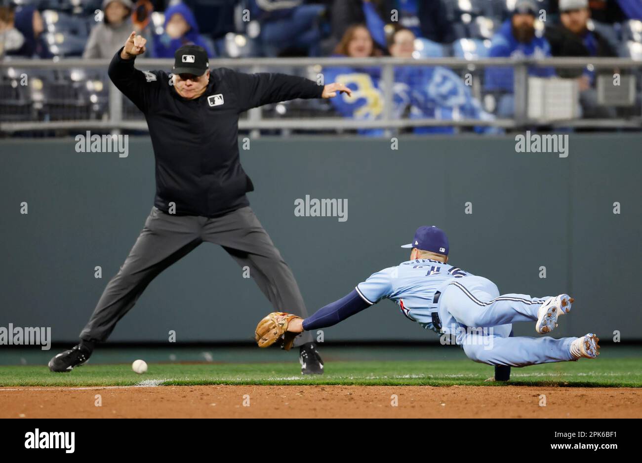 Third base umpire Jerry Layne, left, avoids the ball as Toronto Blue ...