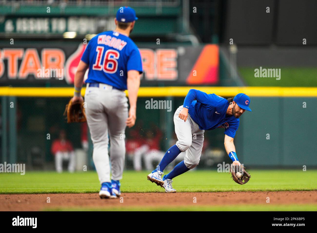 Chicago Cubs shortstop Dansby Swanson fields a ball in a baseball game ...