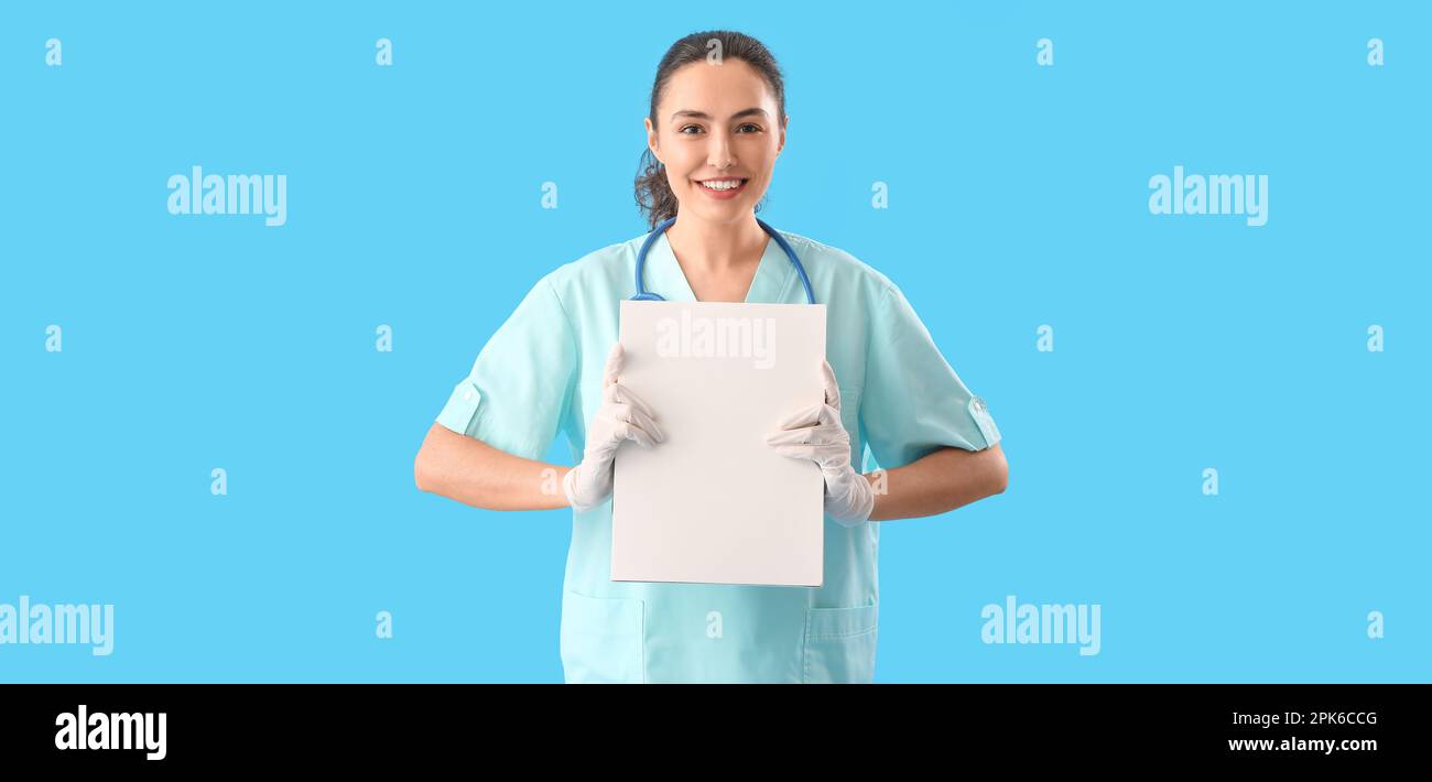 Female medical assistant with blank folder on light blue background ...