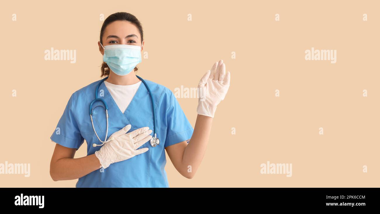 Female medical assistant on beige background with space for text Stock ...