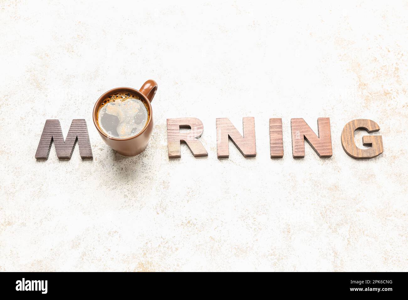 Word MORNING made of wooden letters and cup of coffee on light ...