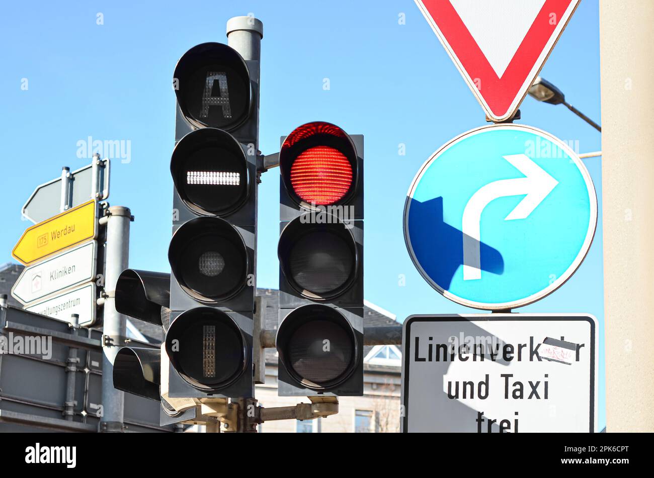 View of traffic lights with road signs in city, closeup Stock Photo - Alamy