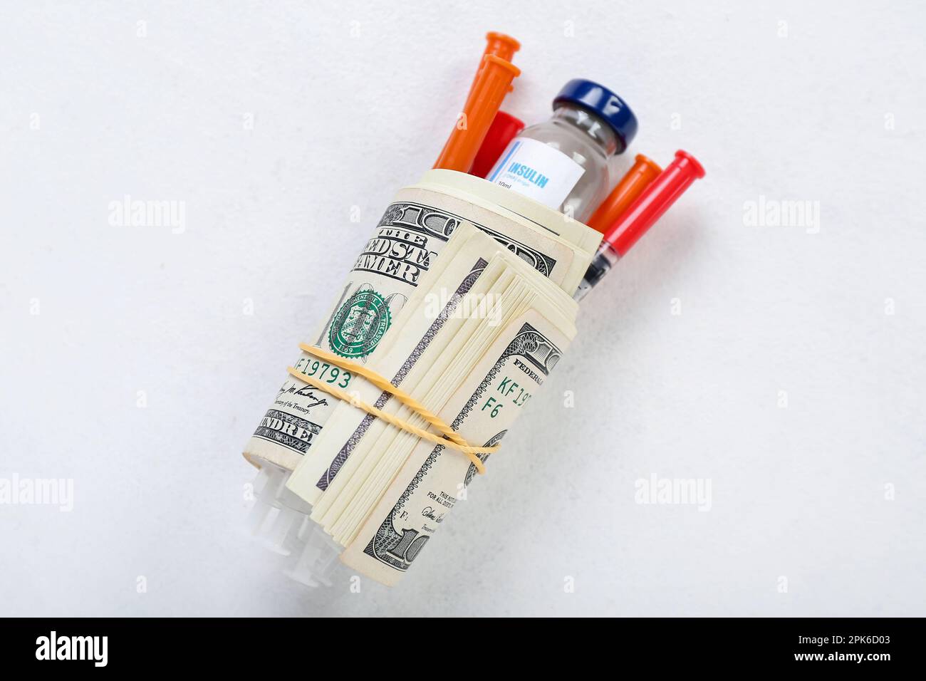 Insulin with syringes and money on white background. Expensive medicine ...
