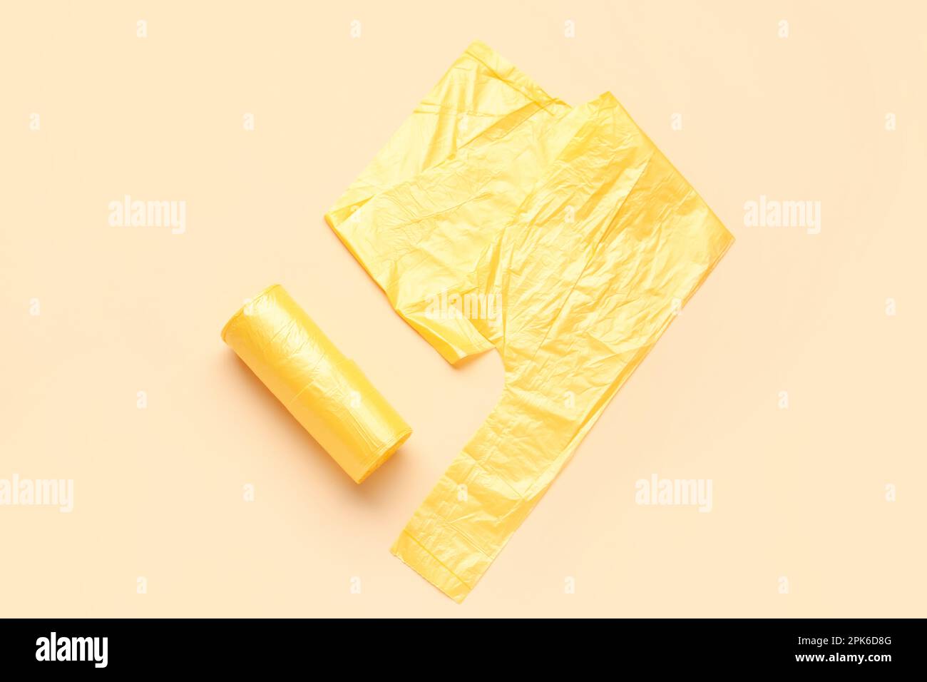 Rolled and unfolded garbage bags on beige background Stock Photo - Alamy