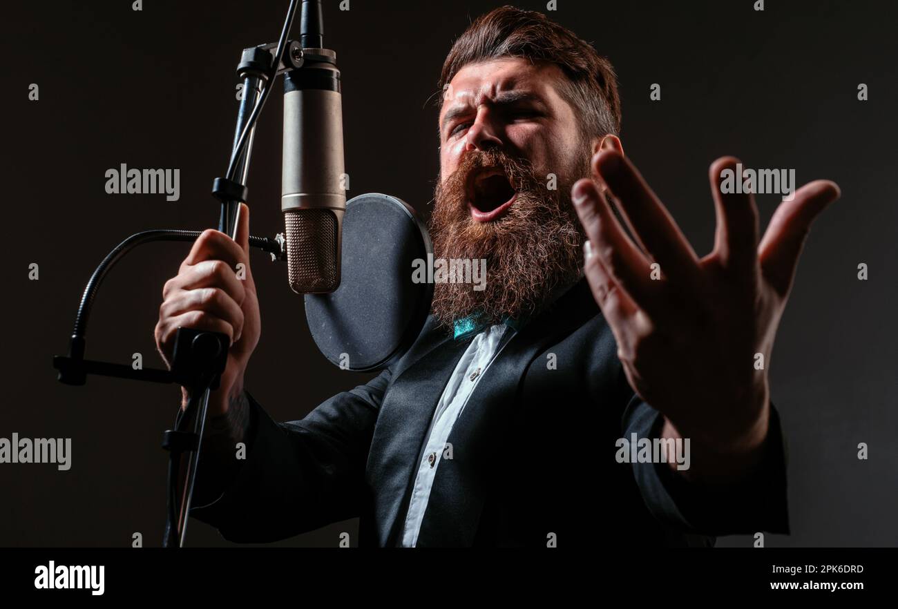 Classic singer in suit. Handsome man in recording studio. Music ...