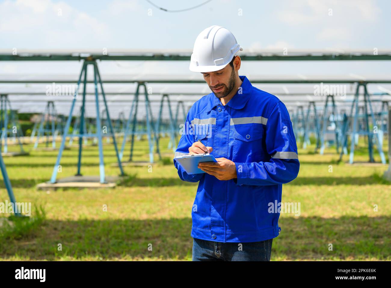 Workers installing solar panels, Engineer team at solar panel farm ...