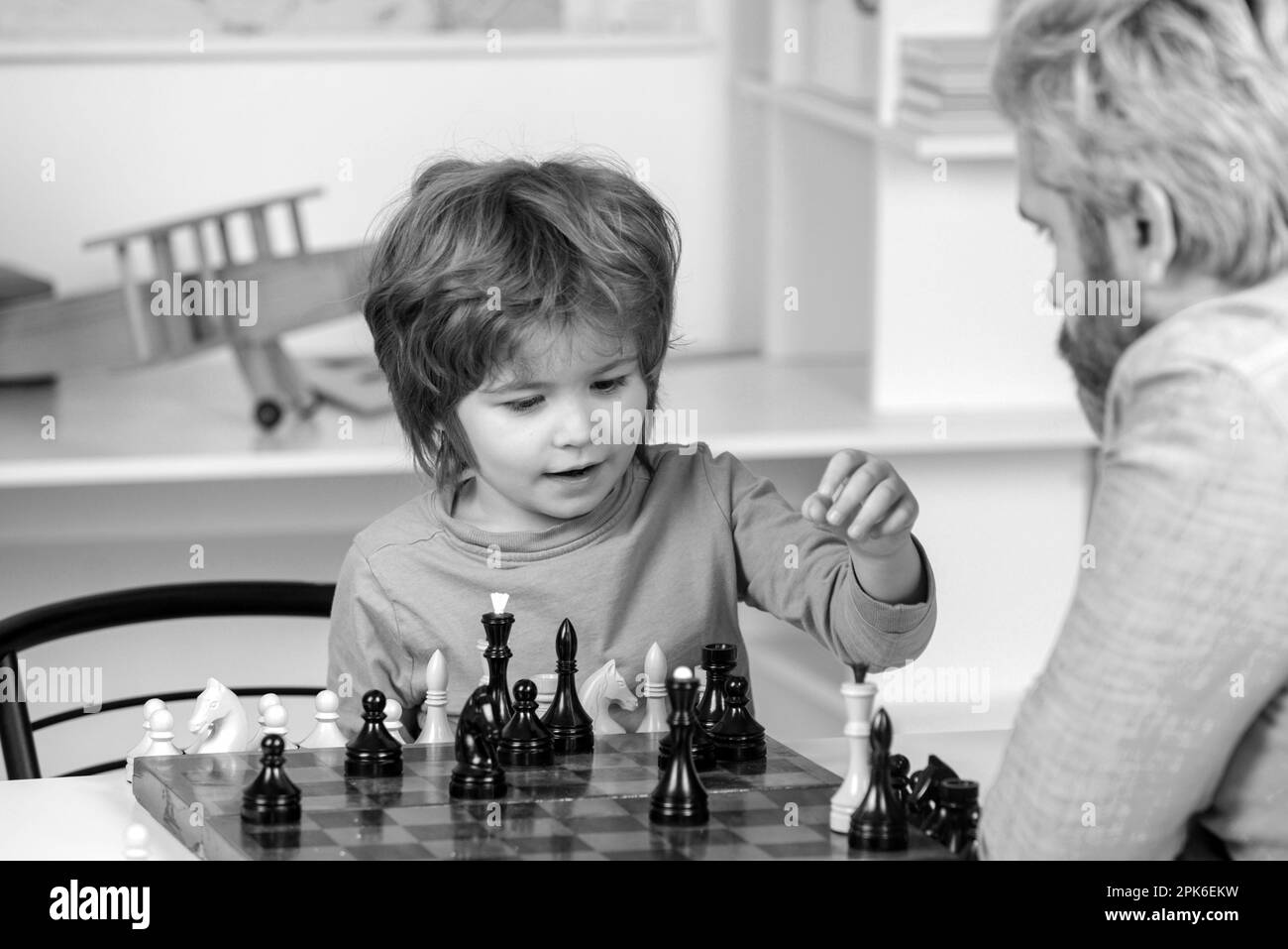 Little clever boy thinking about chess. Chess success and winning. Back ...