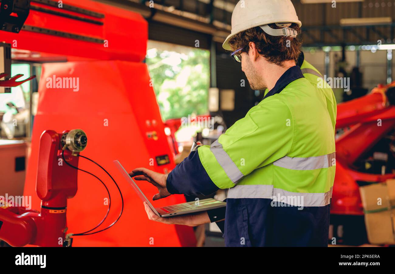 Portrait of happy male mechanical engineer in white hard hat and safety ...