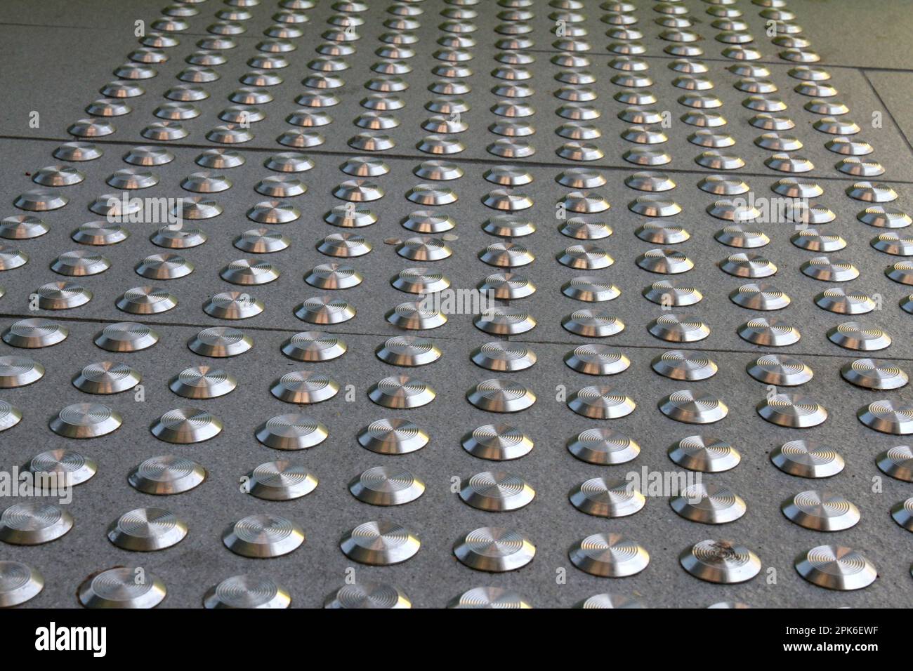 Random street photography of a metal studded pad for walking on and to ...