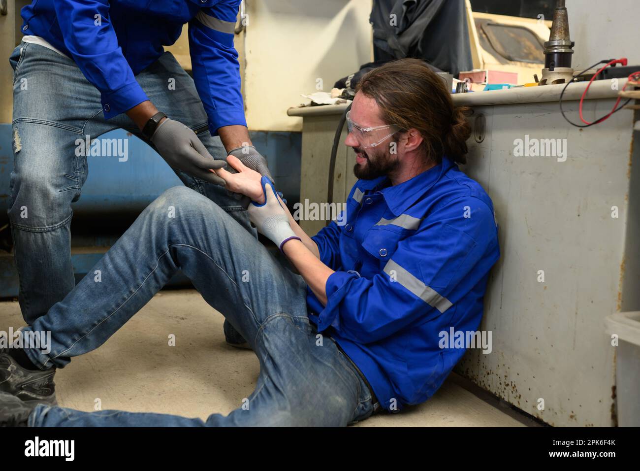 Engineer worker with accident at factory during working Stock Photo - Alamy
