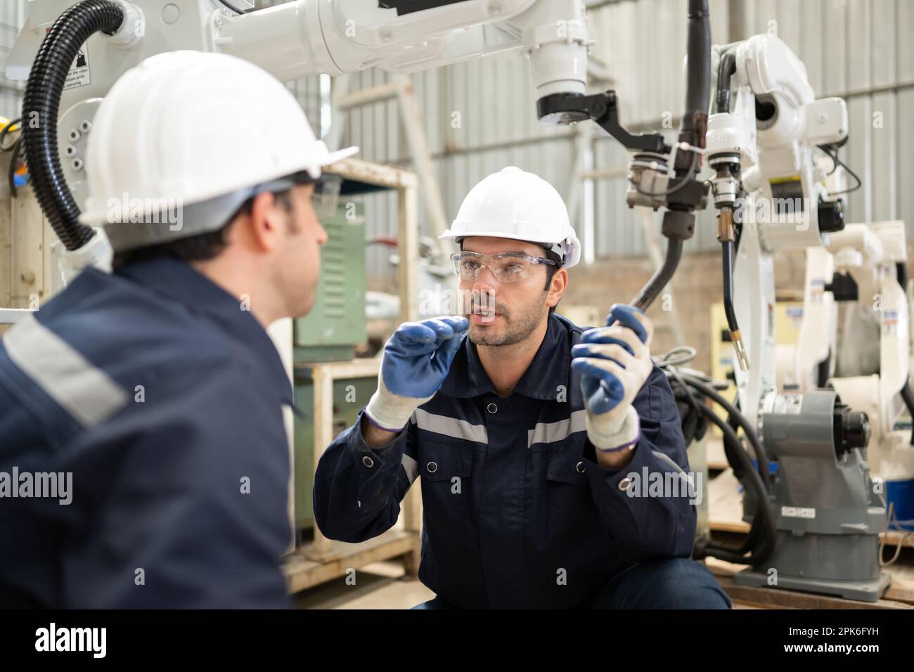 Engineer technician controlling robotic hi-res stock photography and ...
