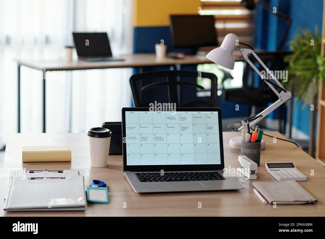 Planner on laptop screen in open space company office Stock Photo - Alamy