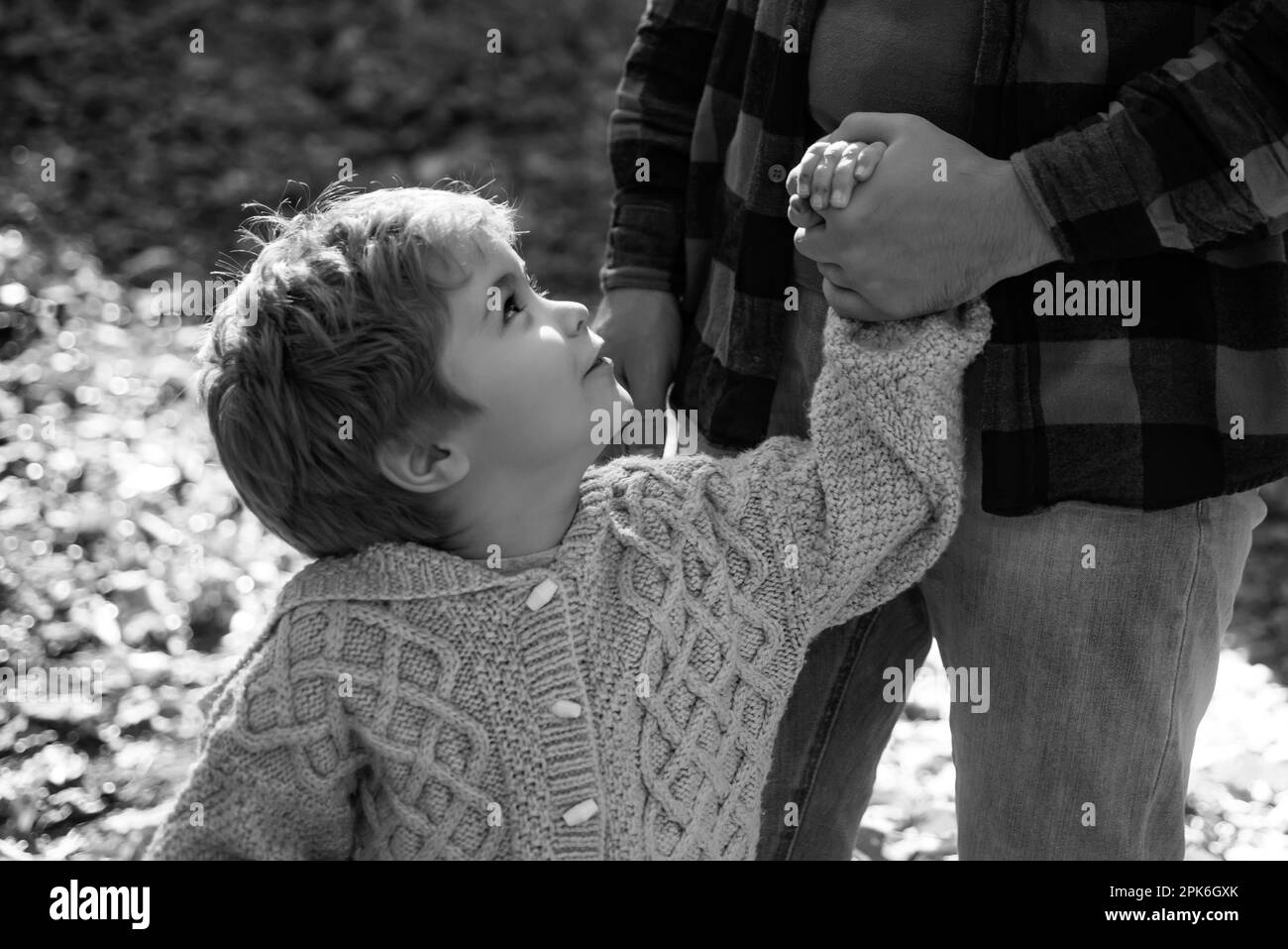 Father and son walking together in the park, fall day. Kid and his ...