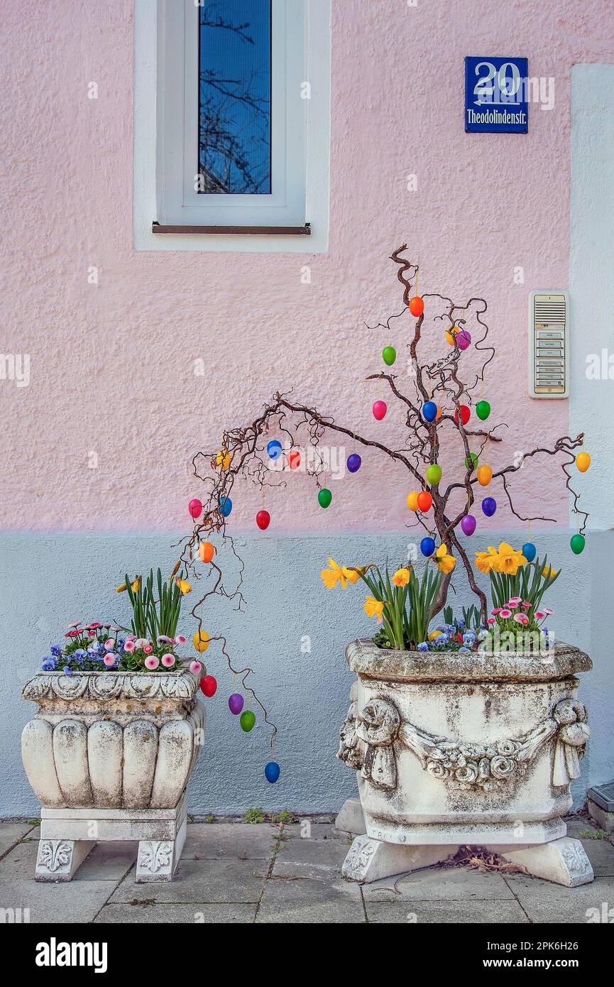Easter eggs and spring flowers in front of pink house wall, Munich ...
